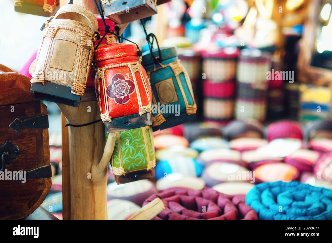 Traditional handcrafted thai rice boxes hanging from a market stall ...