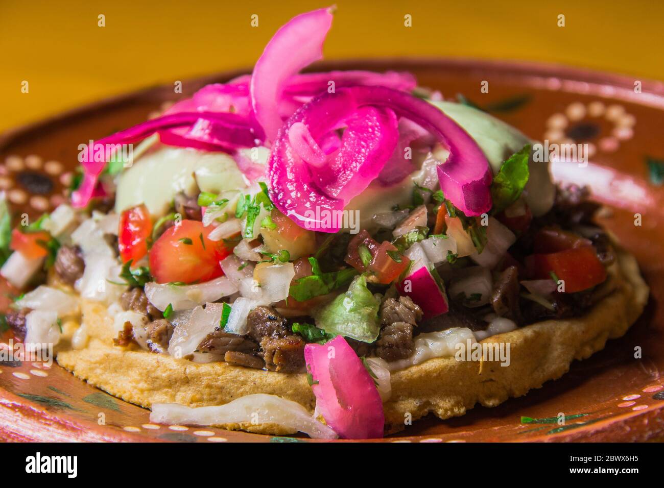 Meat sope with guacamole and onion Stock Photo - Alamy