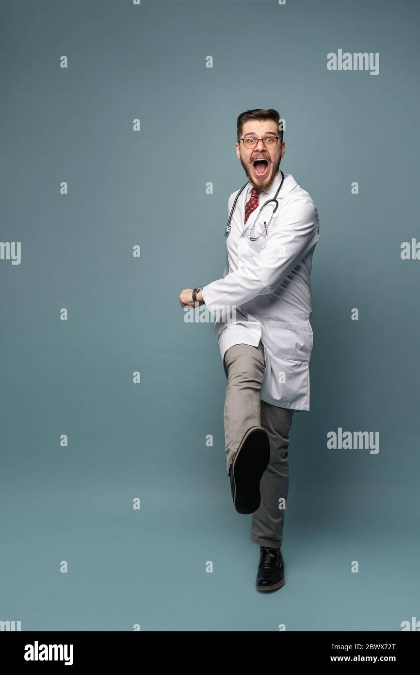 A portrait of a medical doctor posing against gray background Stock ...