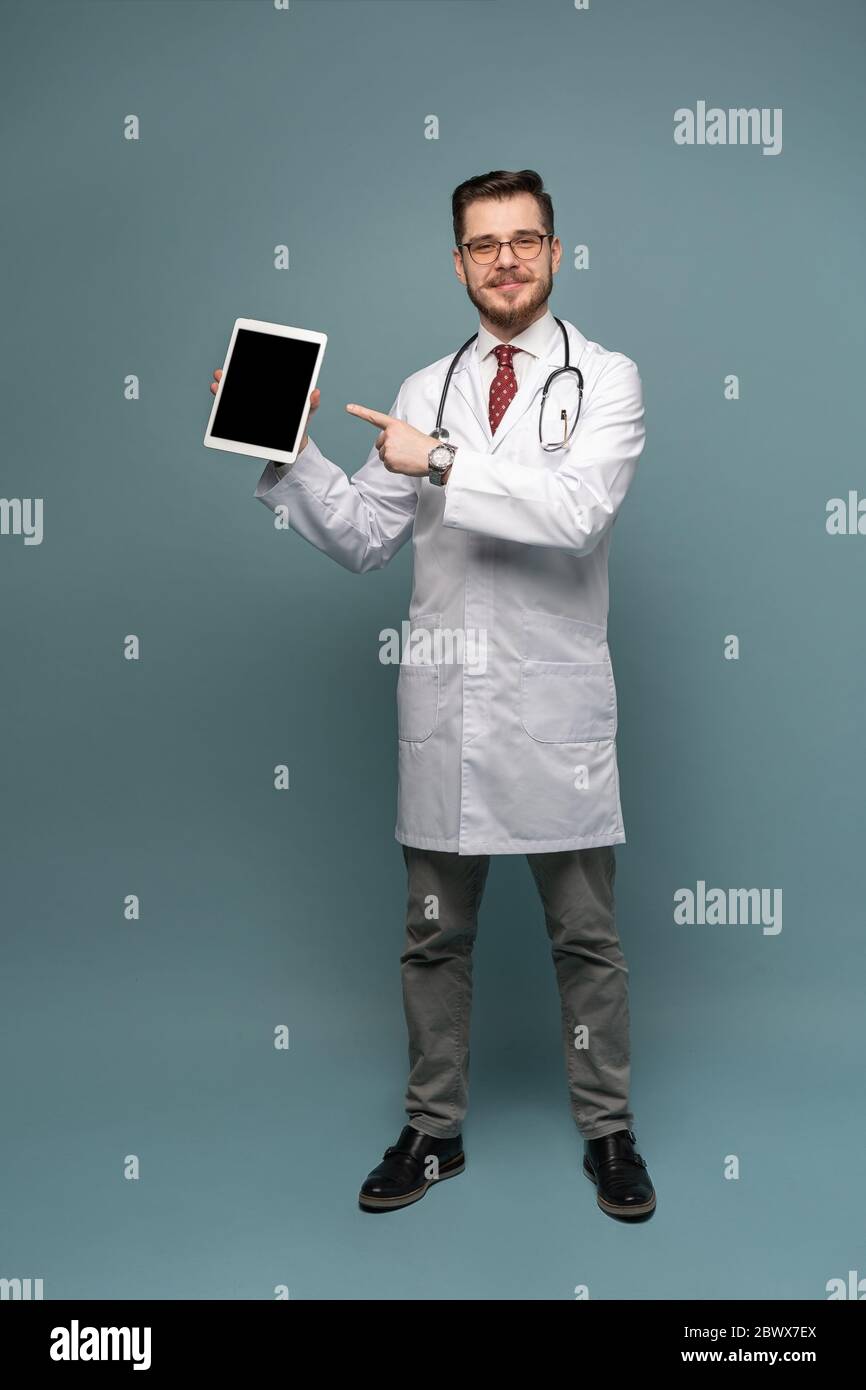 A portrait of a medical doctor posing against gray background Stock ...