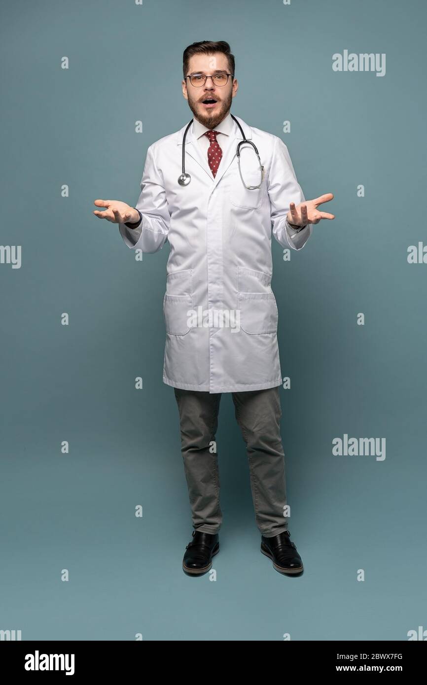 A portrait of a medical doctor posing against gray background Stock ...
