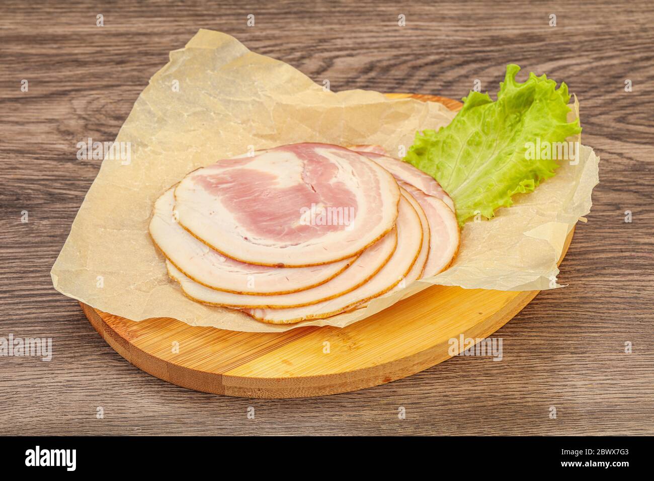 Sliced Italian Pancetta sausage over board Stock Photo - Alamy