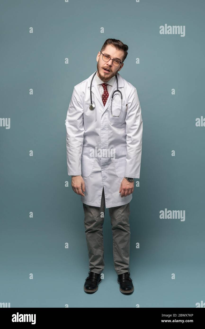 A portrait of a medical doctor posing against gray background Stock ...