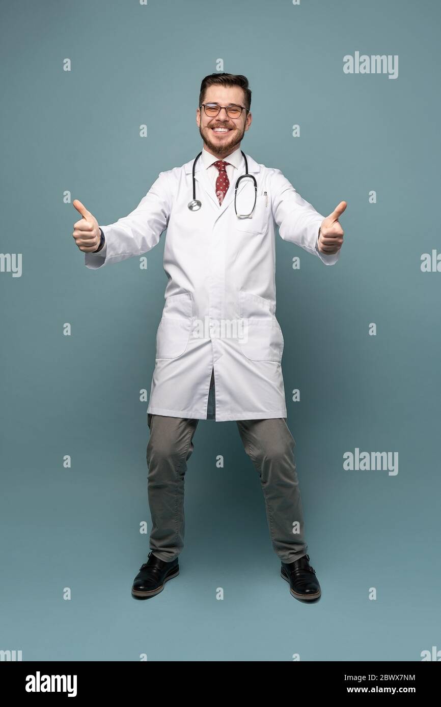 A portrait of a medical doctor posing against gray background Stock ...