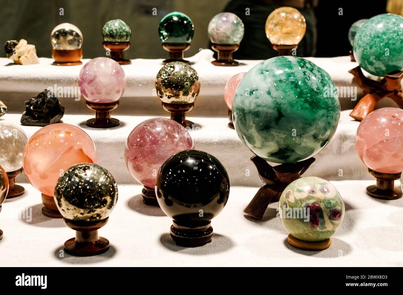 Many crystal therapy spheres on a market stall during a wellness ...