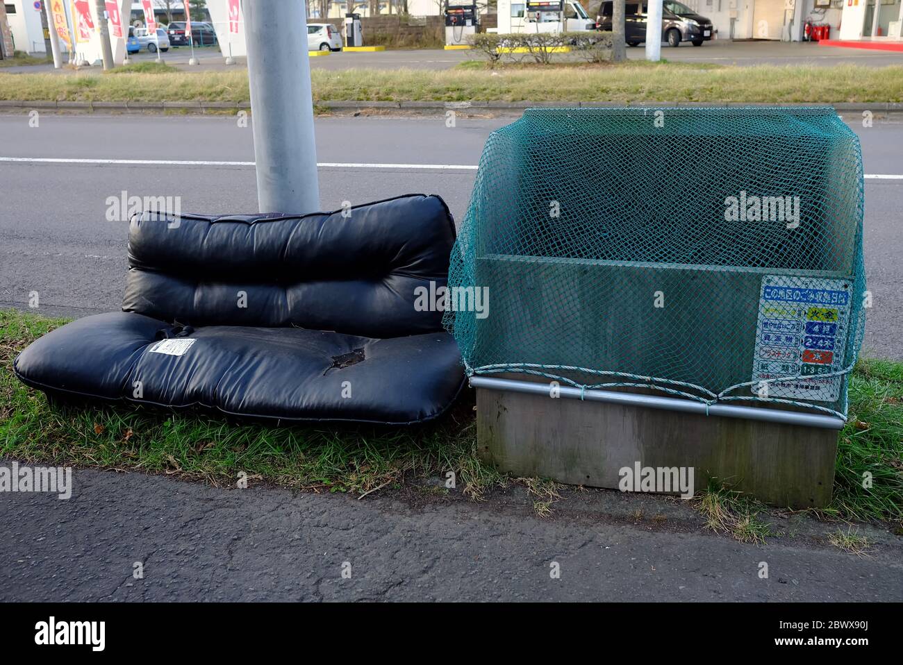 TOMAKOMAI, JAPAN - NOVEMBER 16, 2019: Discarded sofa left beside the ...