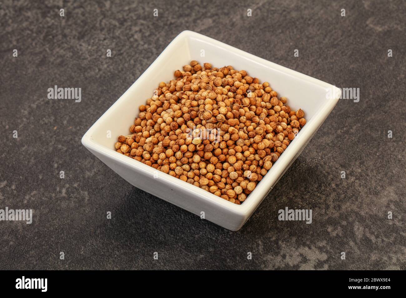 Dry Coriander seeds in the bowl Stock Photo - Alamy