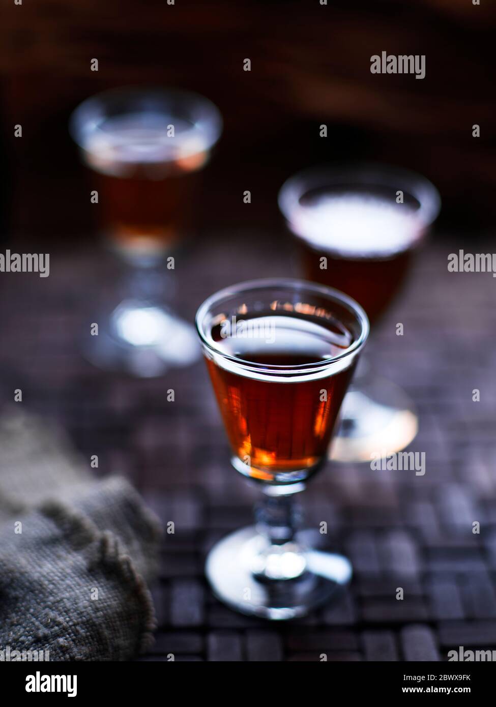 three glasses of brandy on a dark background Stock Photo - Alamy