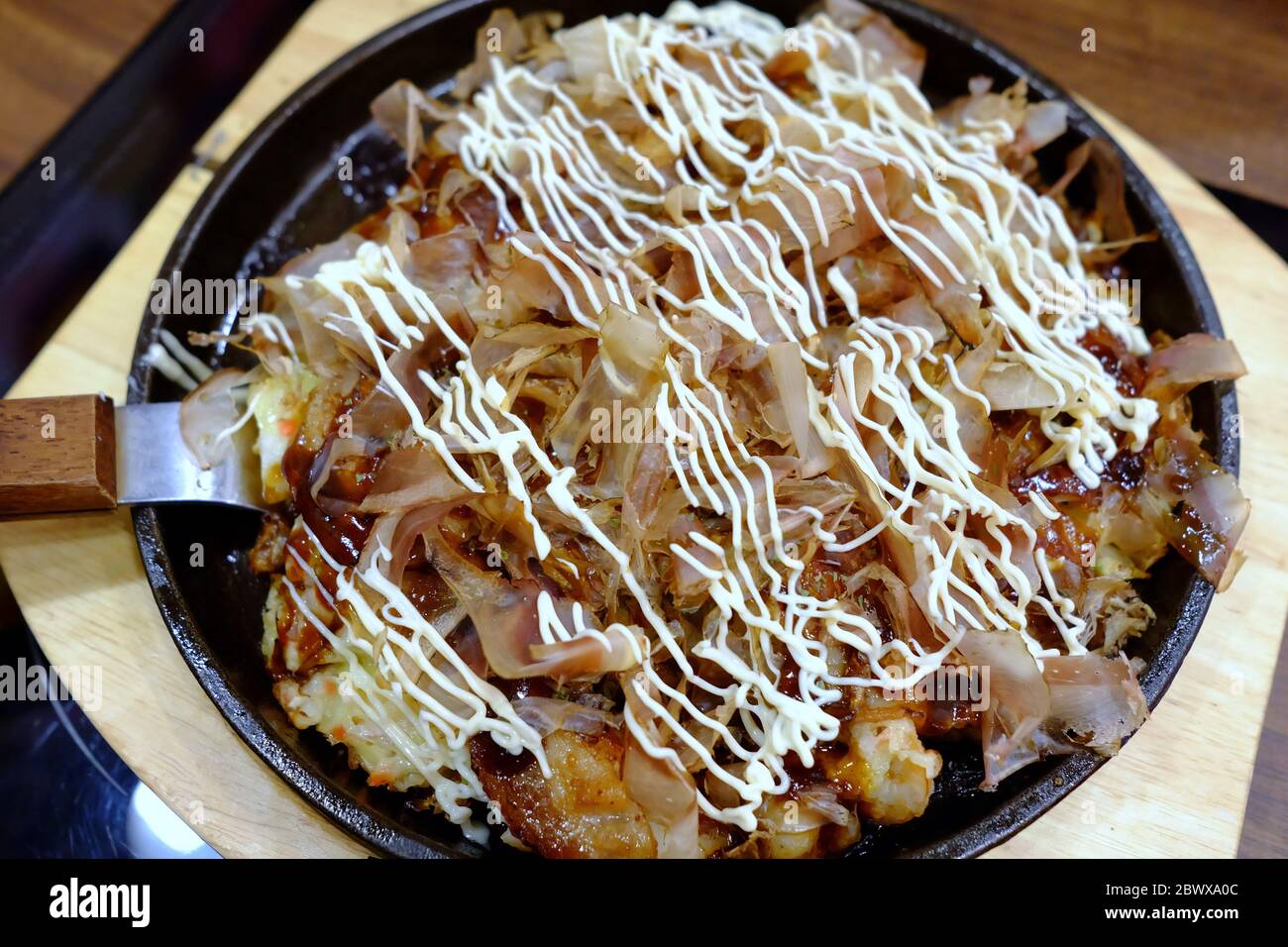 Okonomiyaki in Hot Plate that is a Famous Japanese Recipe Stock Photo ...