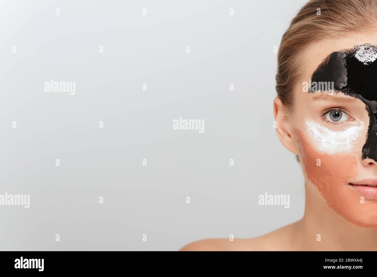 Close up half of young attractive woman with different cosmetic masks ...