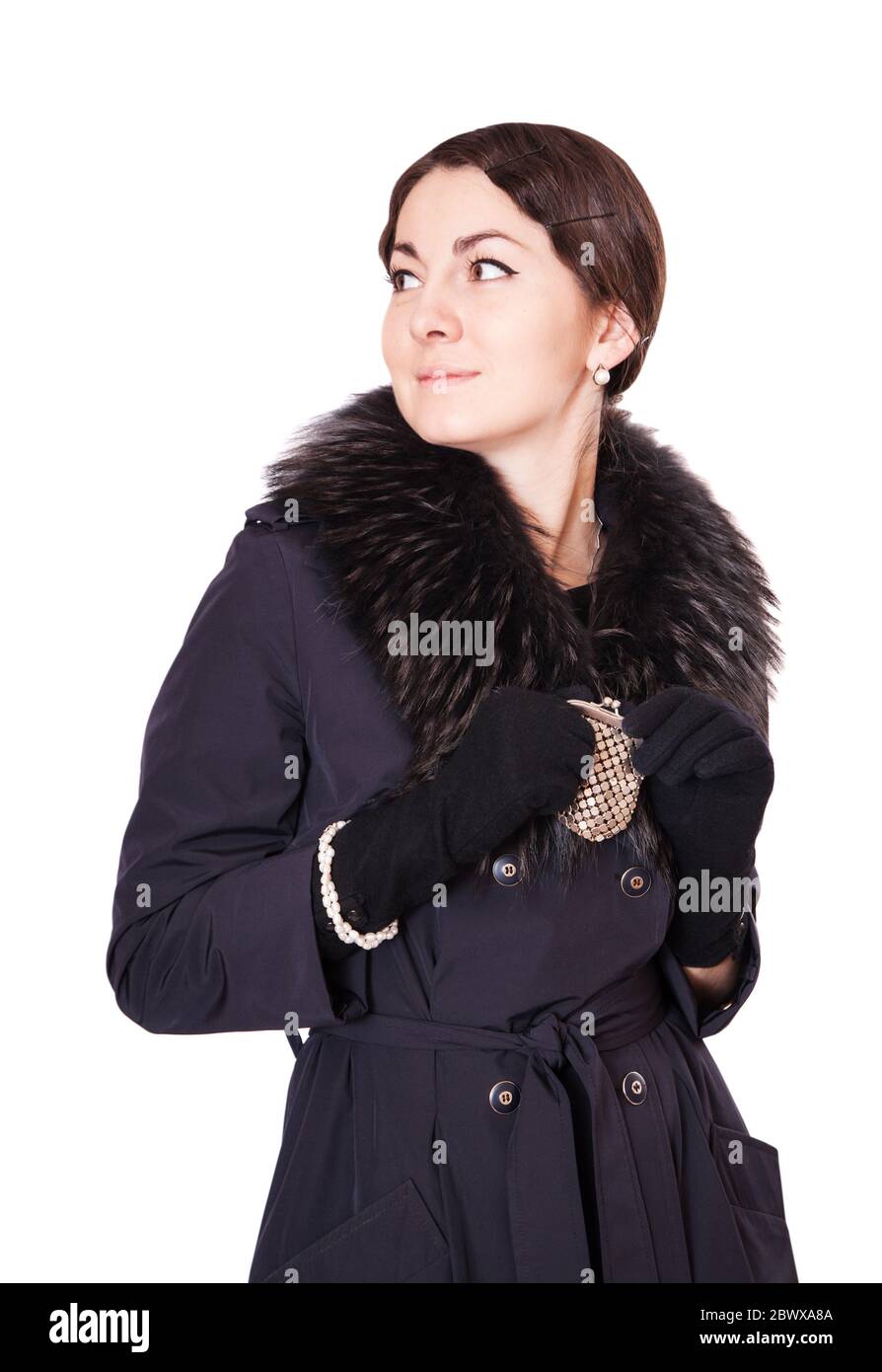 Girl in a black coat holding purse Stock Photo - Alamy