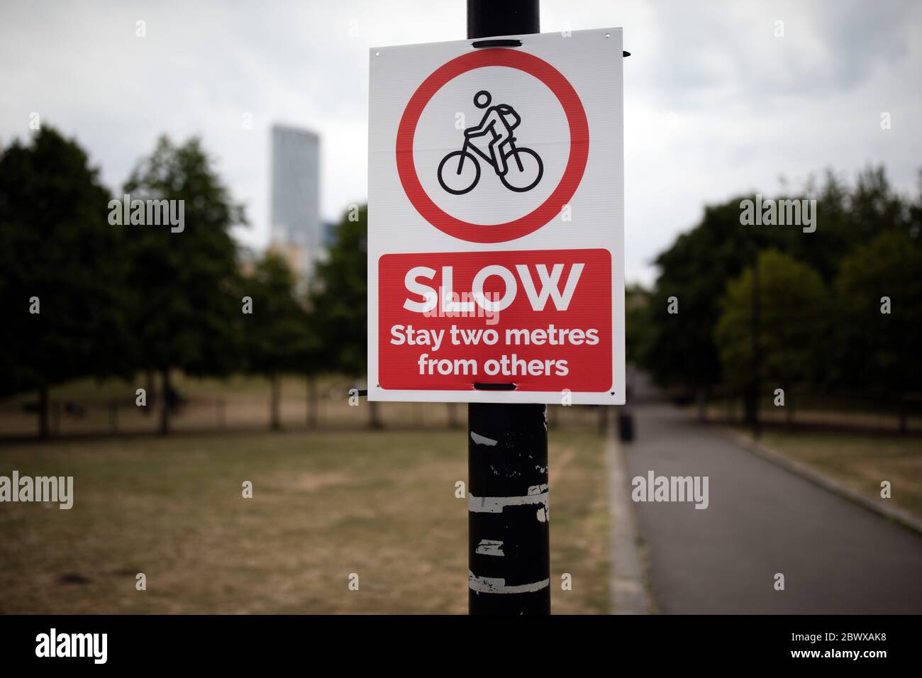 Slow Stay two metres from others sign for cyclists in Ropemakers Field ...