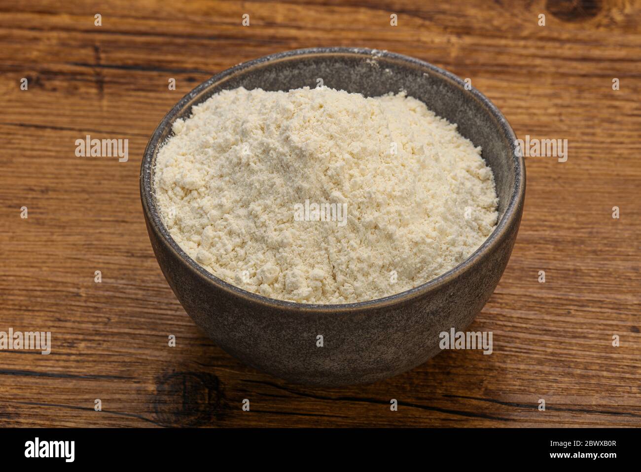 Wheat flour heap in the bowl for cooking Stock Photo - Alamy