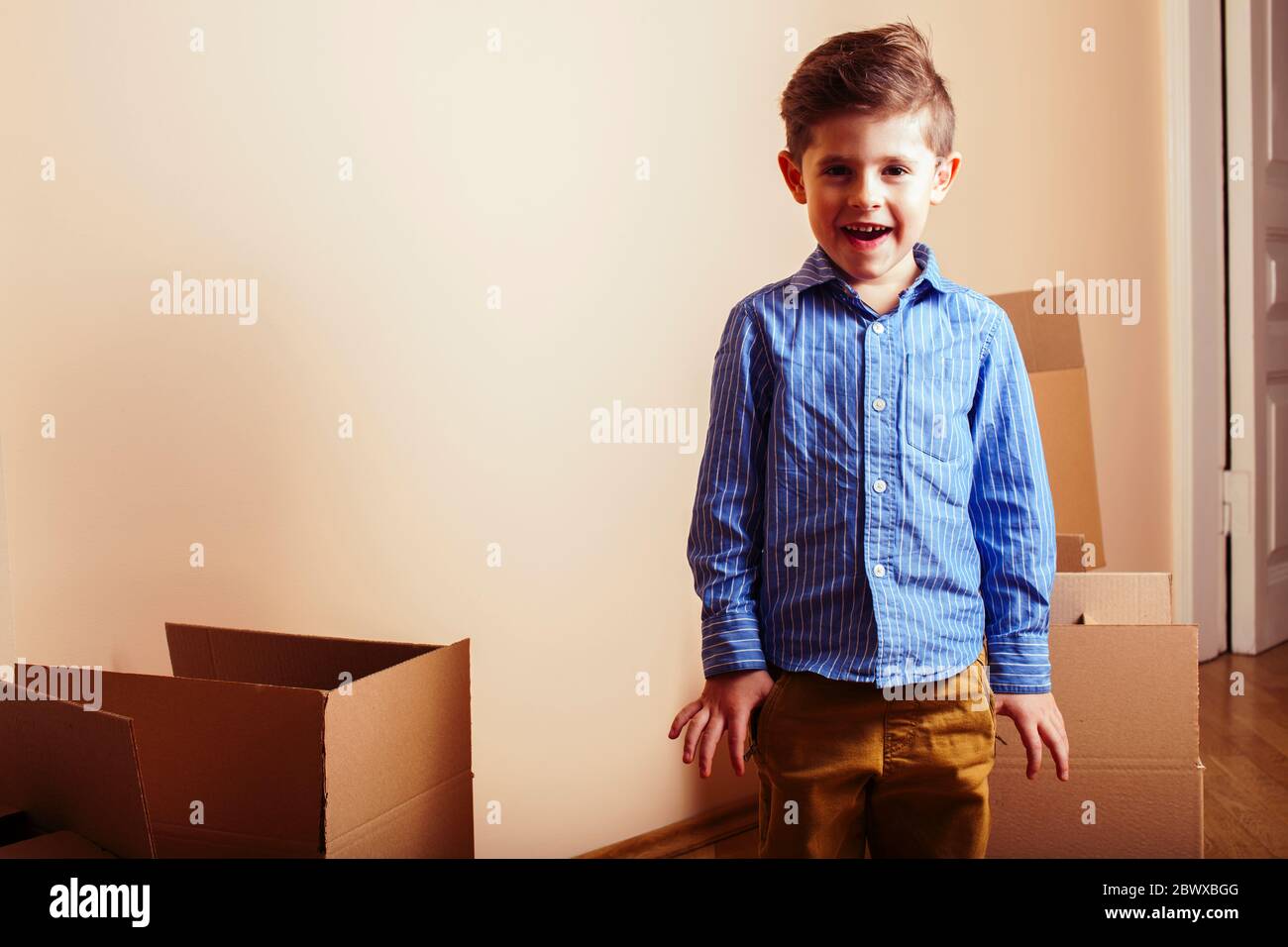 little cute boy in empty room, move to new house. home alone among ...