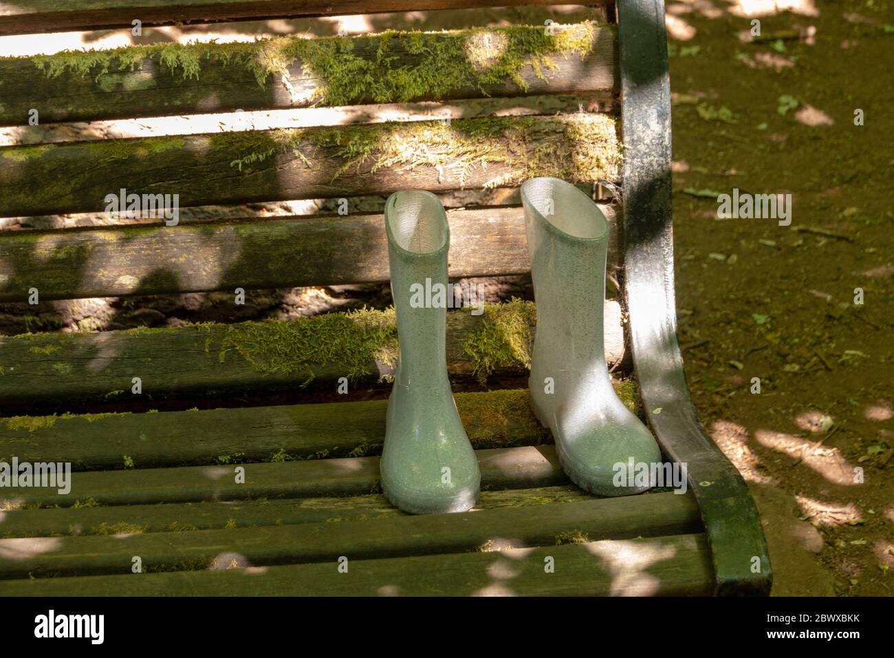 a close up view of a pair of kids boots that have been left on a park ...