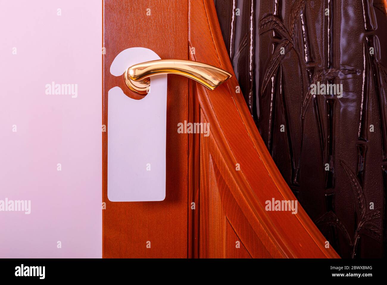 Do not disturb sign at the door. Empty label or flyer on a door handle ...