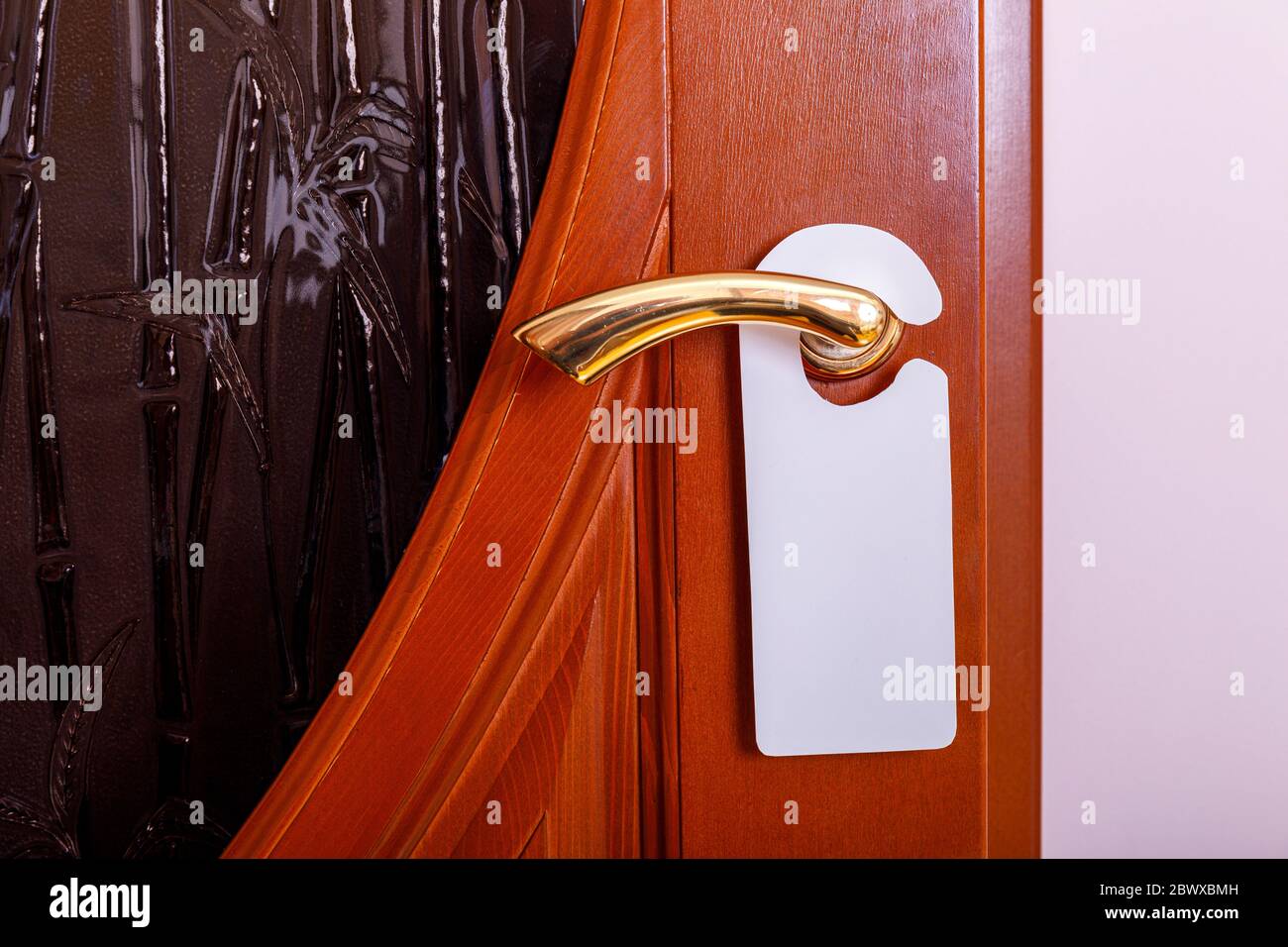 Do not disturb sign at the door. Empty label or flyer on a door handle ...