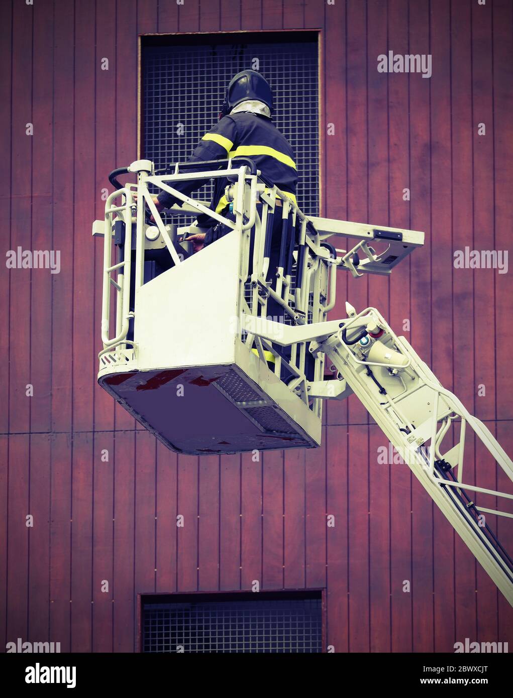 firefighter on the aerial platform during practice with old toned ...