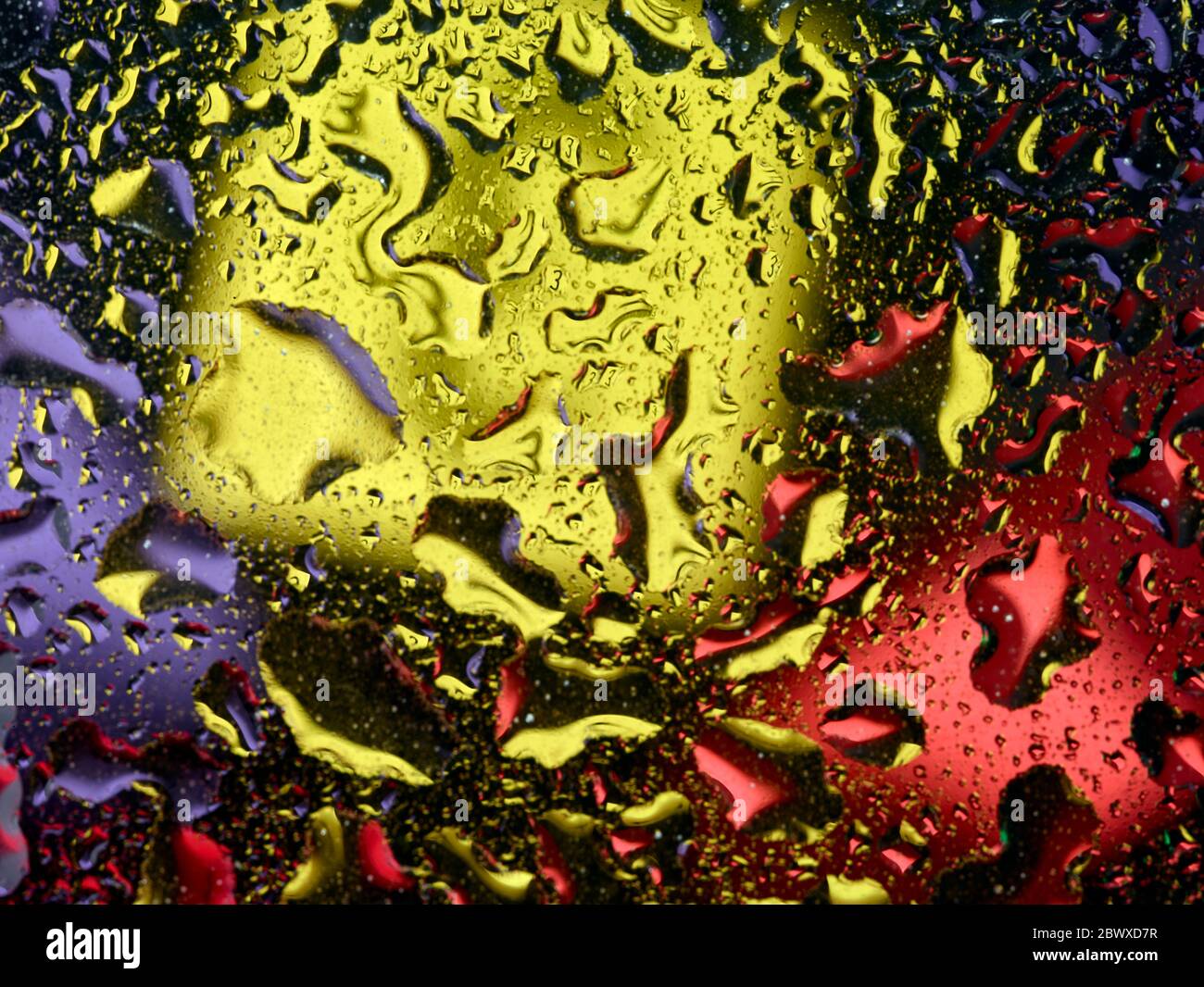 Water droplet patterns on hard surface with colourful background Stock ...