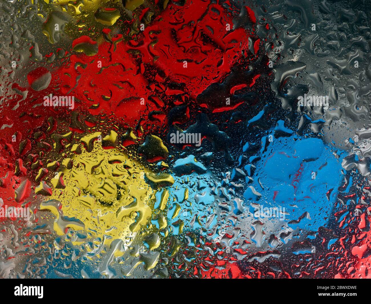 Water drop (drops and droplets) on hard surface with colourful ...