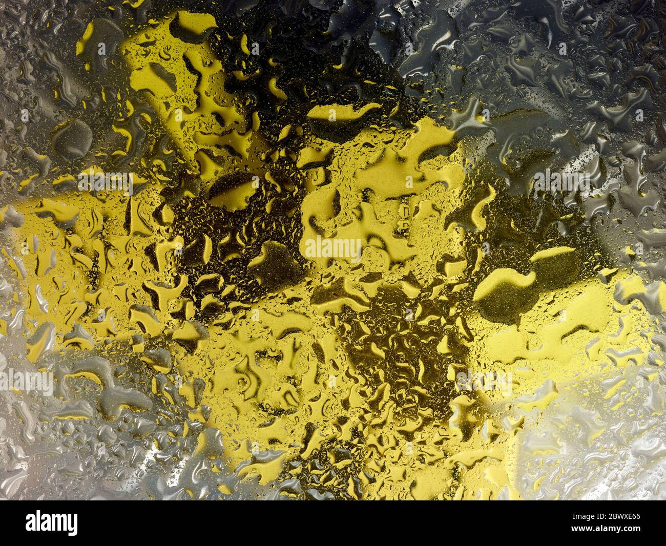 Water drop (drops and droplets) on hard surface with colourful ...
