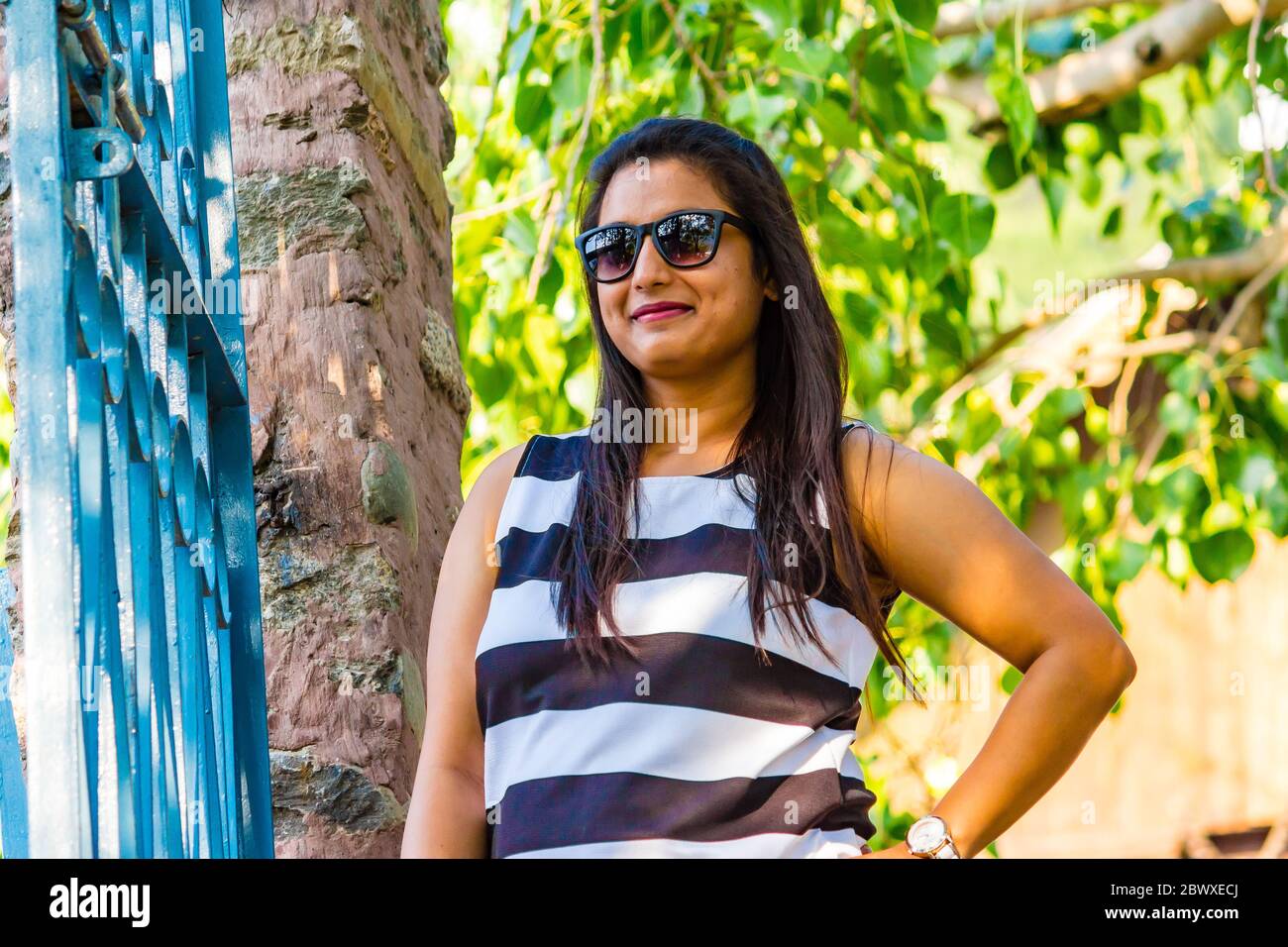 A tourist girl posing for a camera shoot in the green mountains of ...