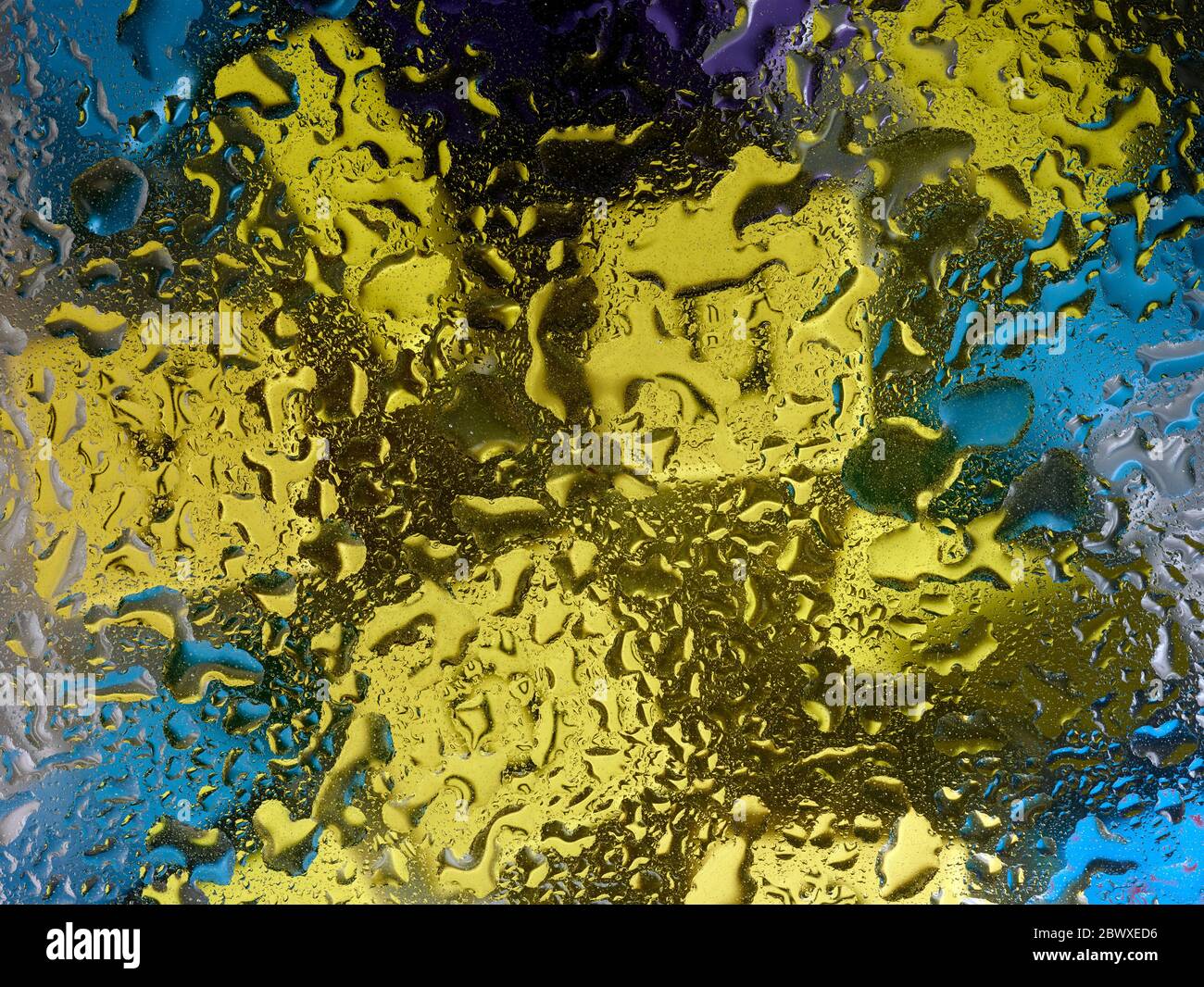 Water drop (drops and droplets) on hard surface with colourful ...