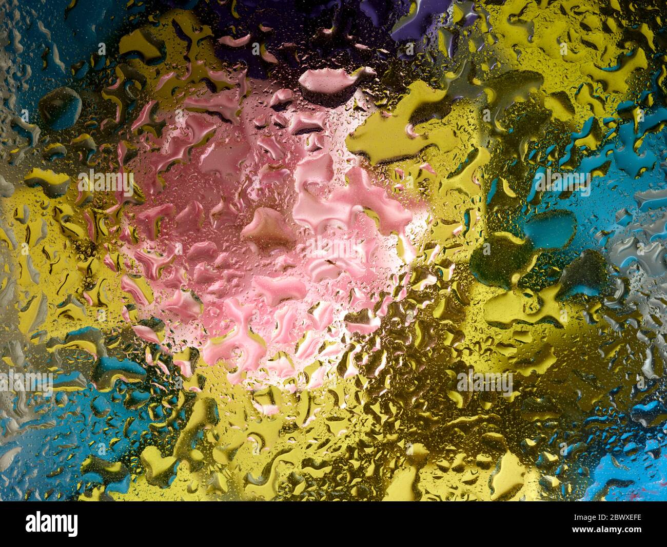 Water drop (drops and droplets) on hard surface with colourful ...
