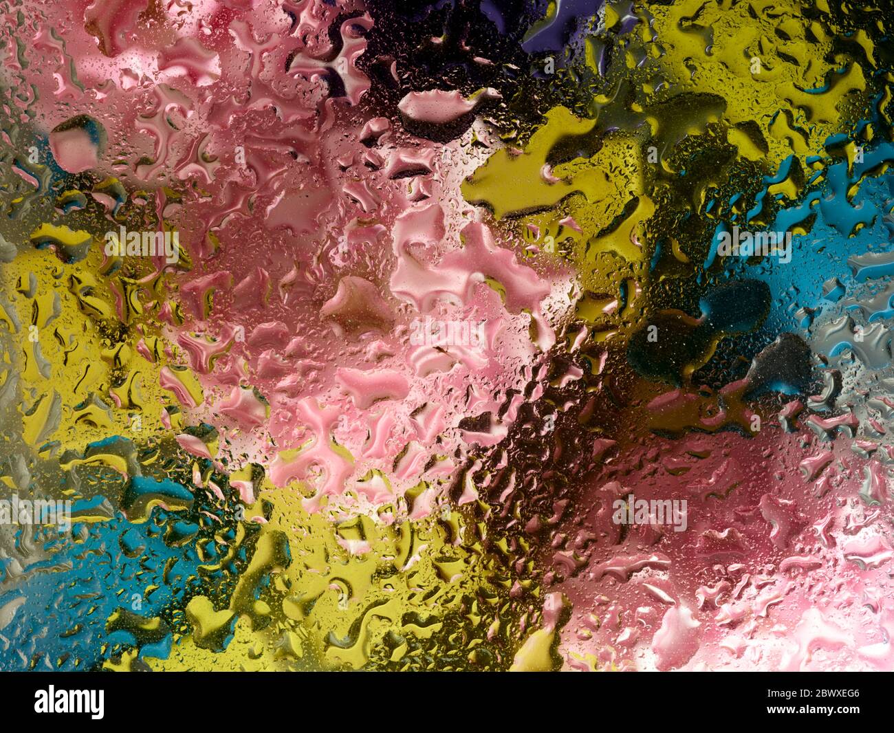 Water drop (drops and droplets) on hard surface with colourful ...