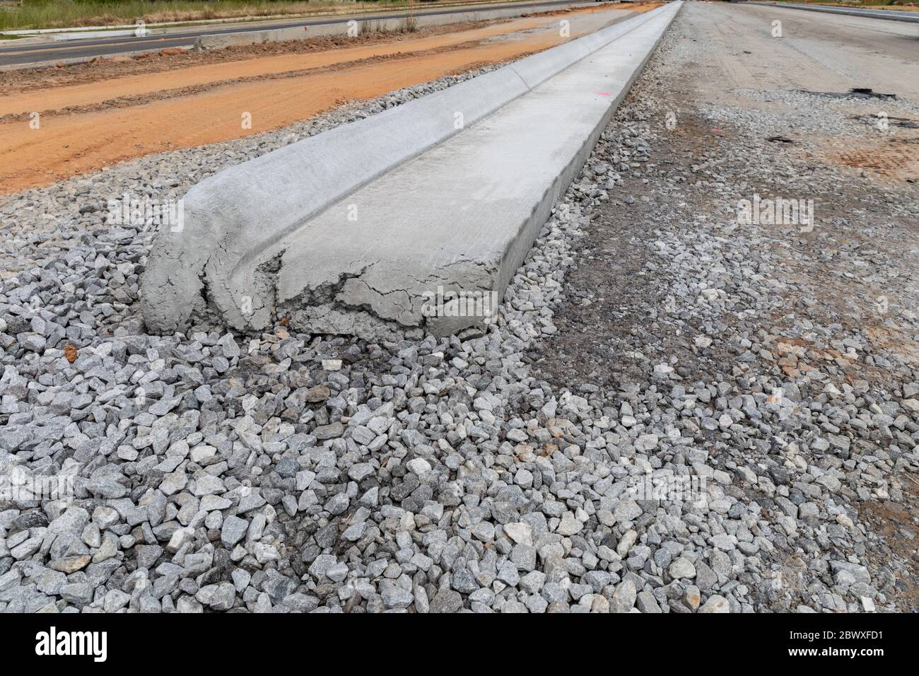 Long view down freshly extruded street curb, concrete extrusion road ...