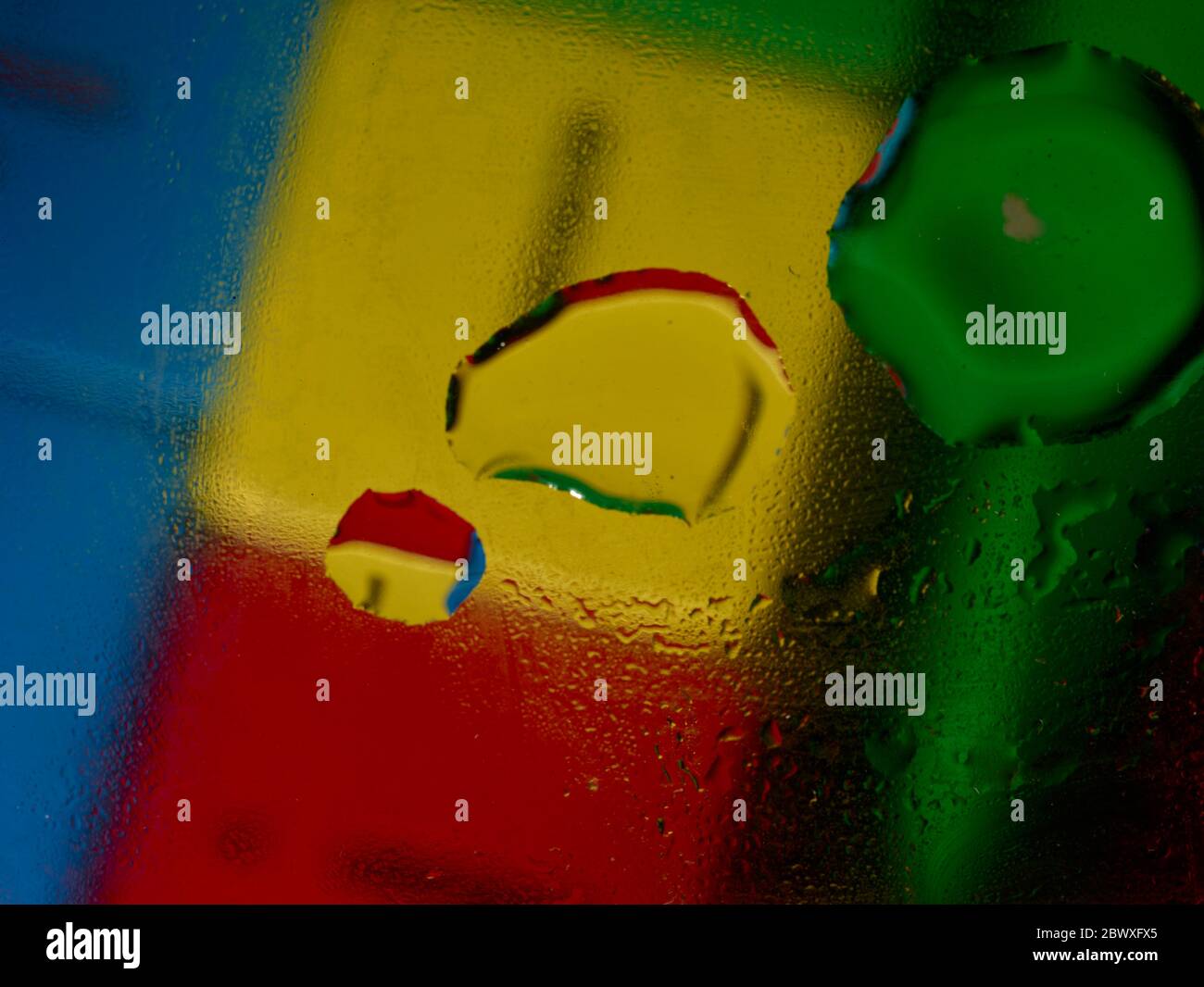 Water drop (drops and droplets) on hard surface with colourful ...
