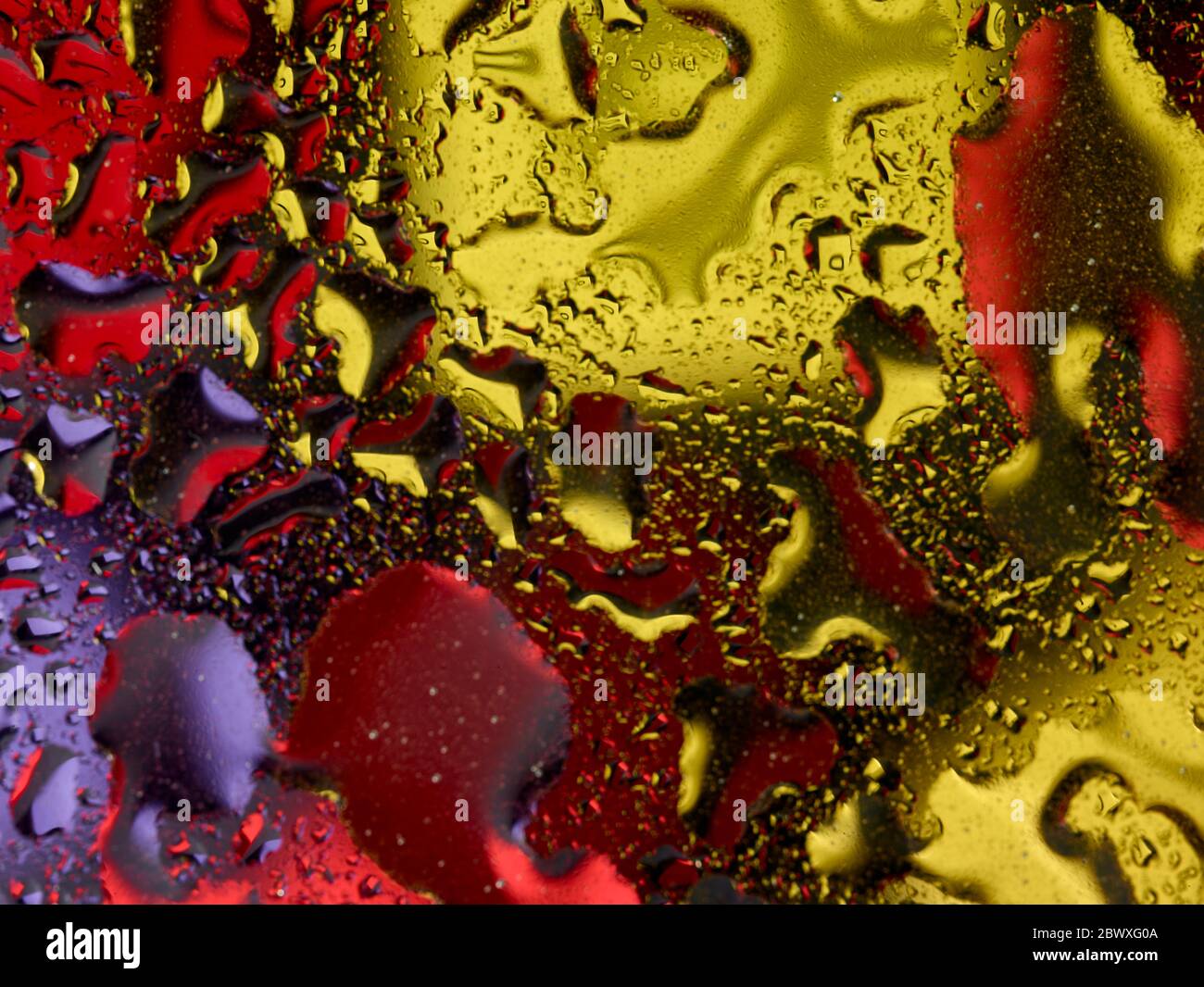 Water drop (drops and droplets) on hard surface with colourful ...