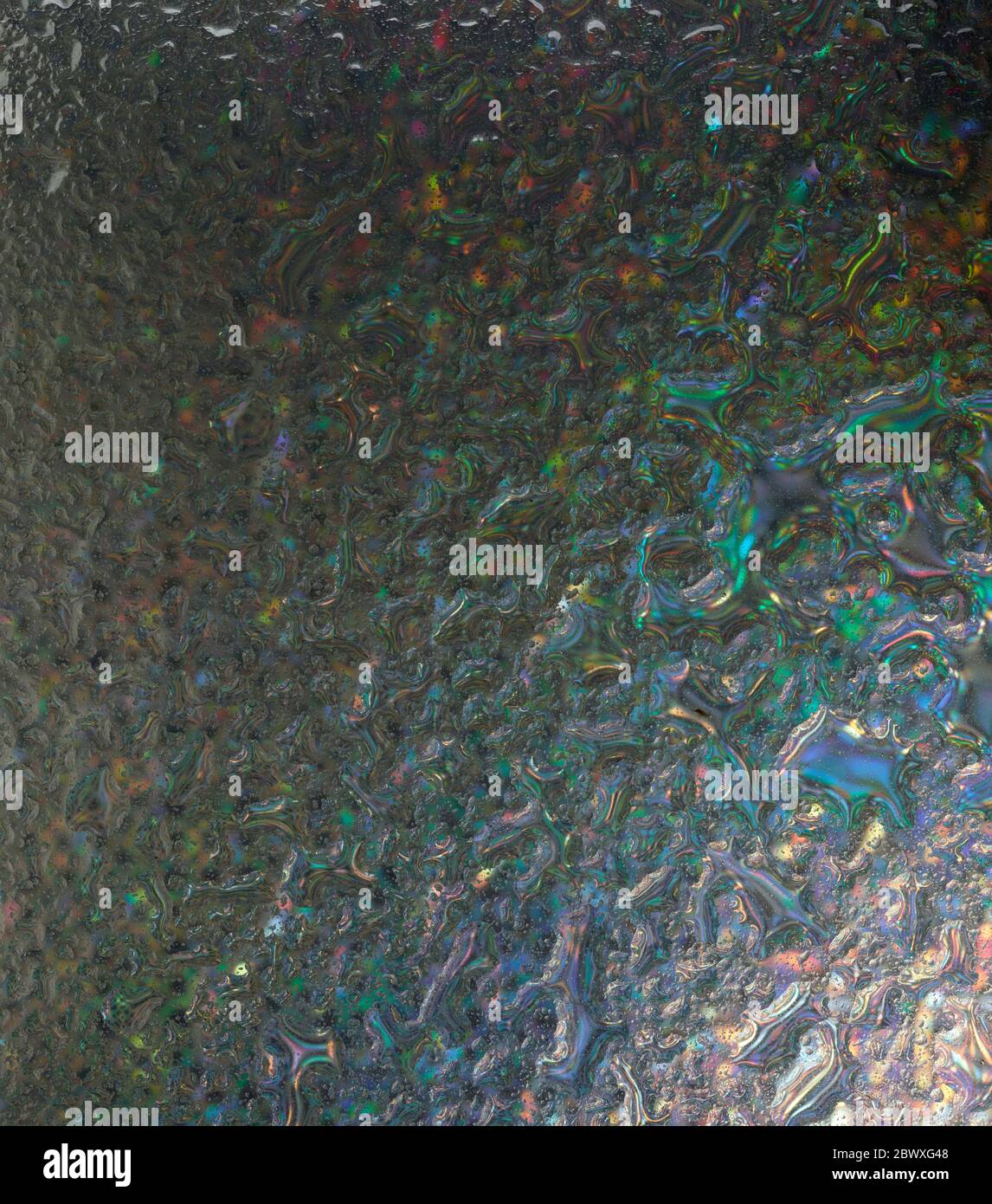 Water drop (drops and droplets) on hard surface with colourful ...