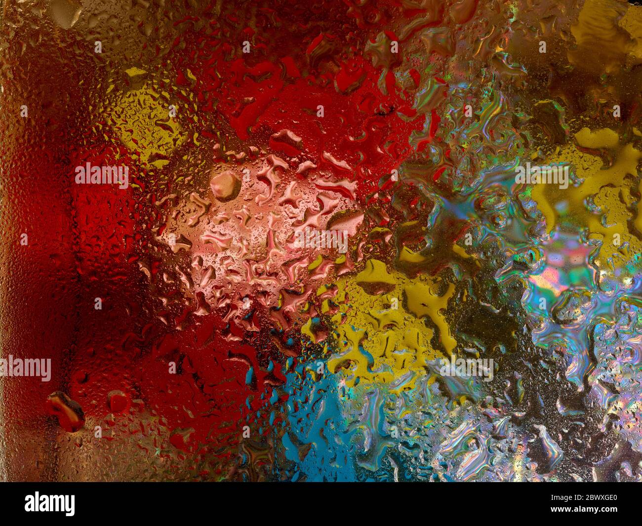 Water drop (drops and droplets) on hard surface with colourful ...