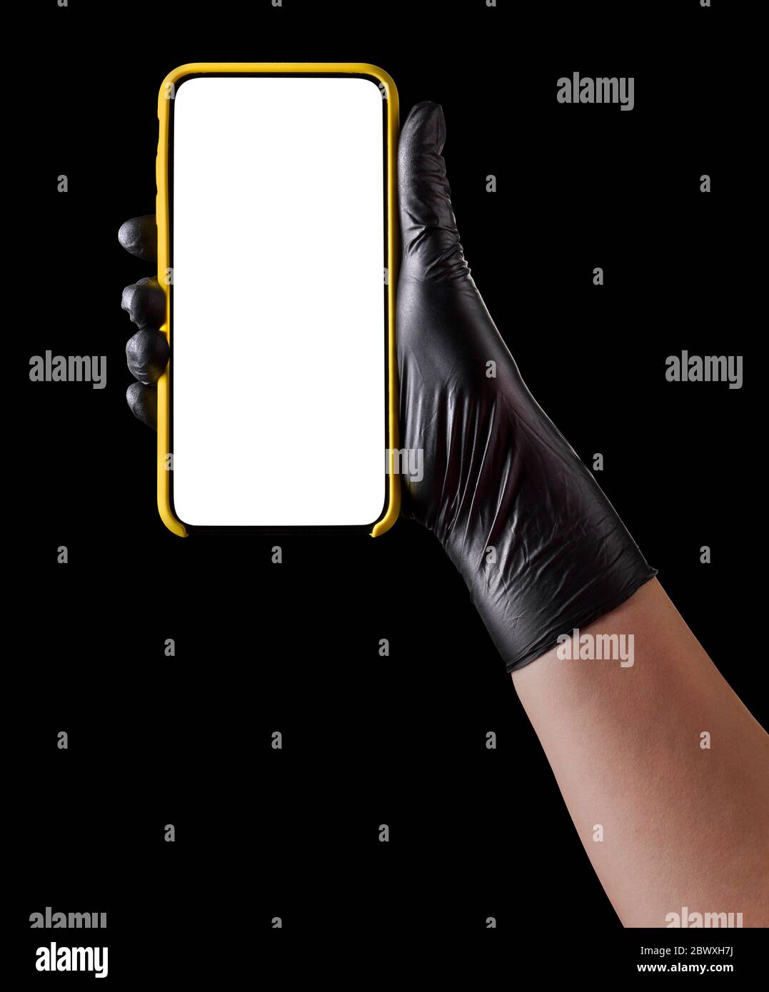 Hand in black glove holding mobile phone with blank screen isolated on ...