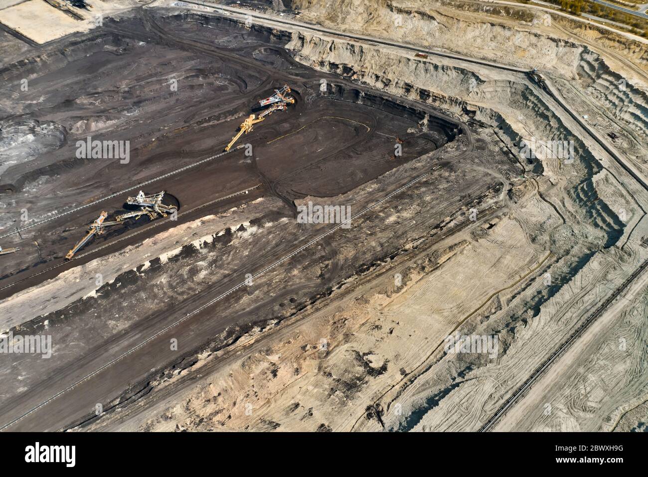 Aerial shoot of quarry with heavy bucket wheel excavators mining a coal ...