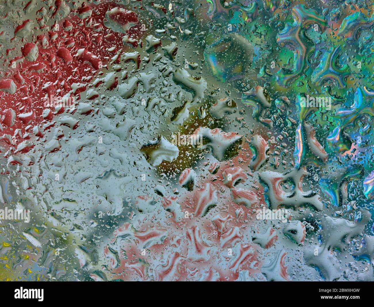 Water drop (drops and droplets) on hard surface with colourful ...