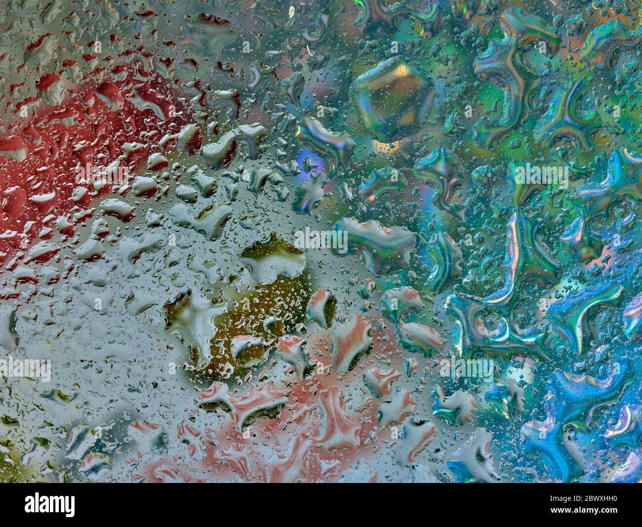 Water drop (drops and droplets) on hard surface with colourful ...