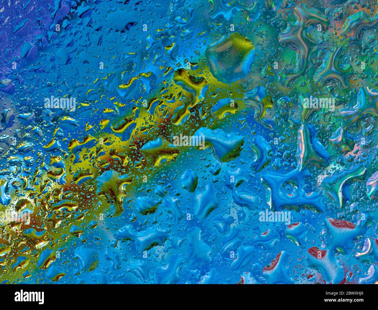 Water drop (drops and droplets) on hard surface with colourful ...