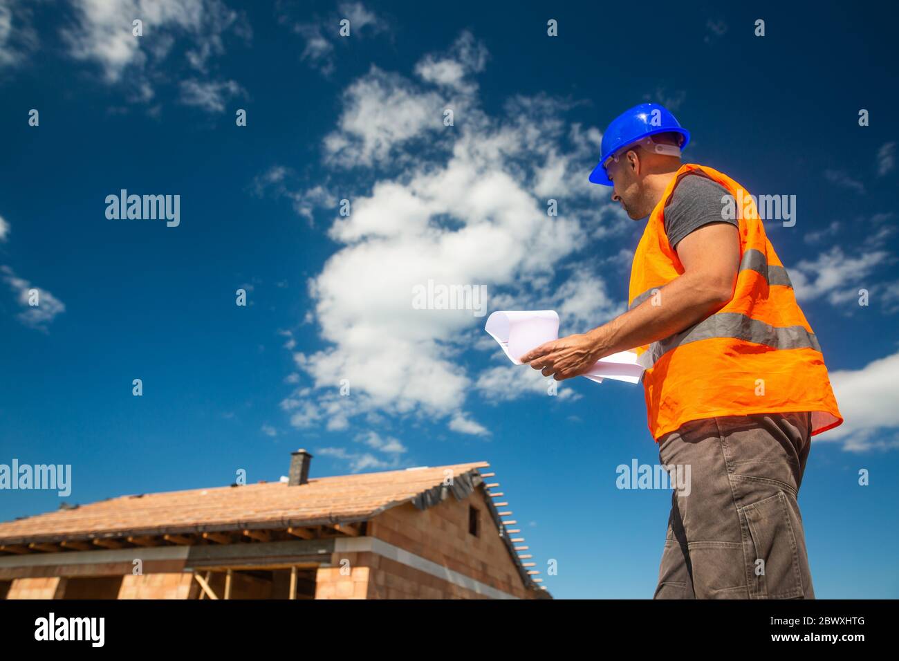 Construction manager with new building hi-res stock photography and ...