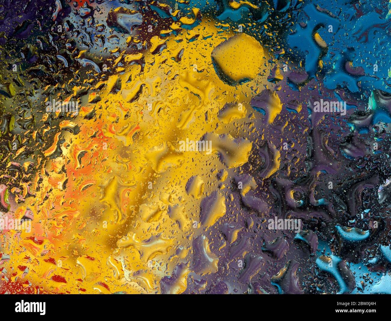 Water drop (drops and droplets) on hard surface with colourful ...