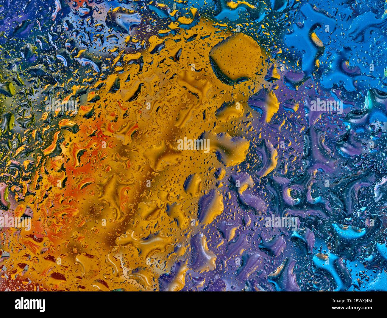 Water drop (drops and droplets) on hard surface with colourful ...