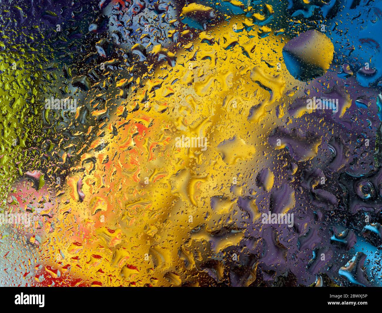 Water drop (drops and droplets) on hard surface with colourful ...