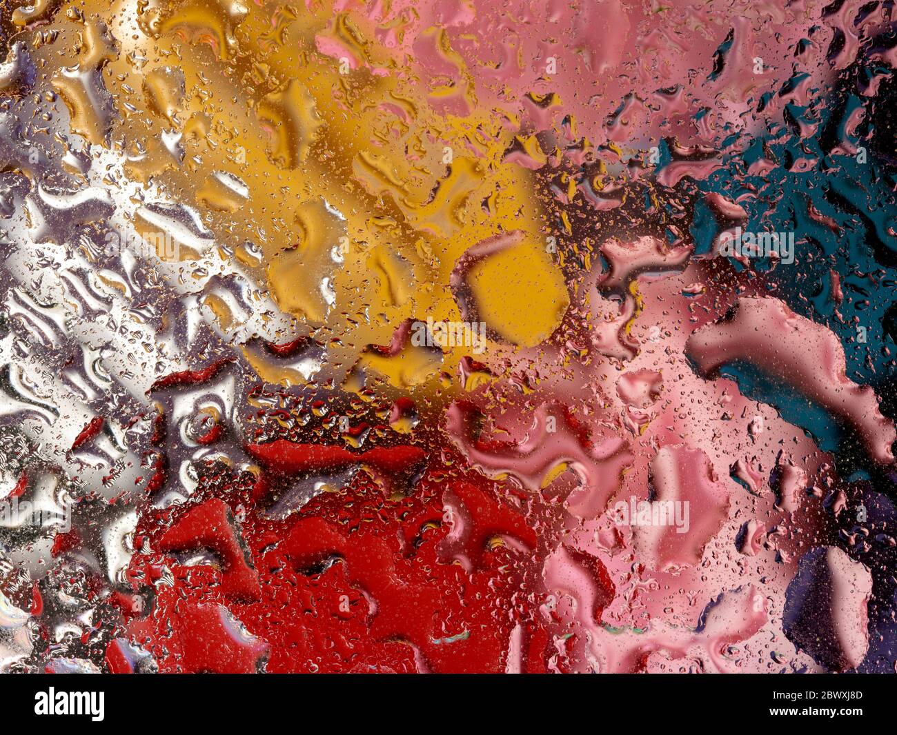 Water drop (drops and droplets) on hard surface with colourful ...