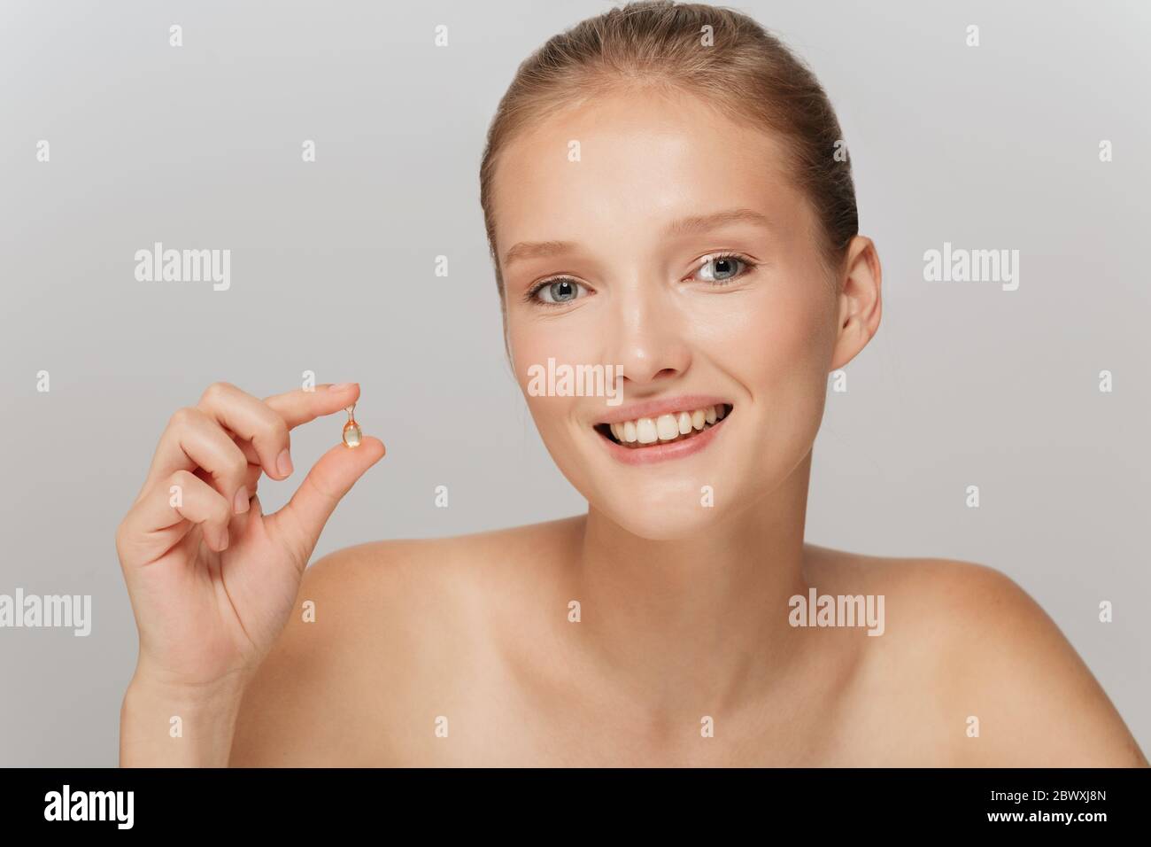 Portrait of beautiful smiling girl without makeup holding little ...