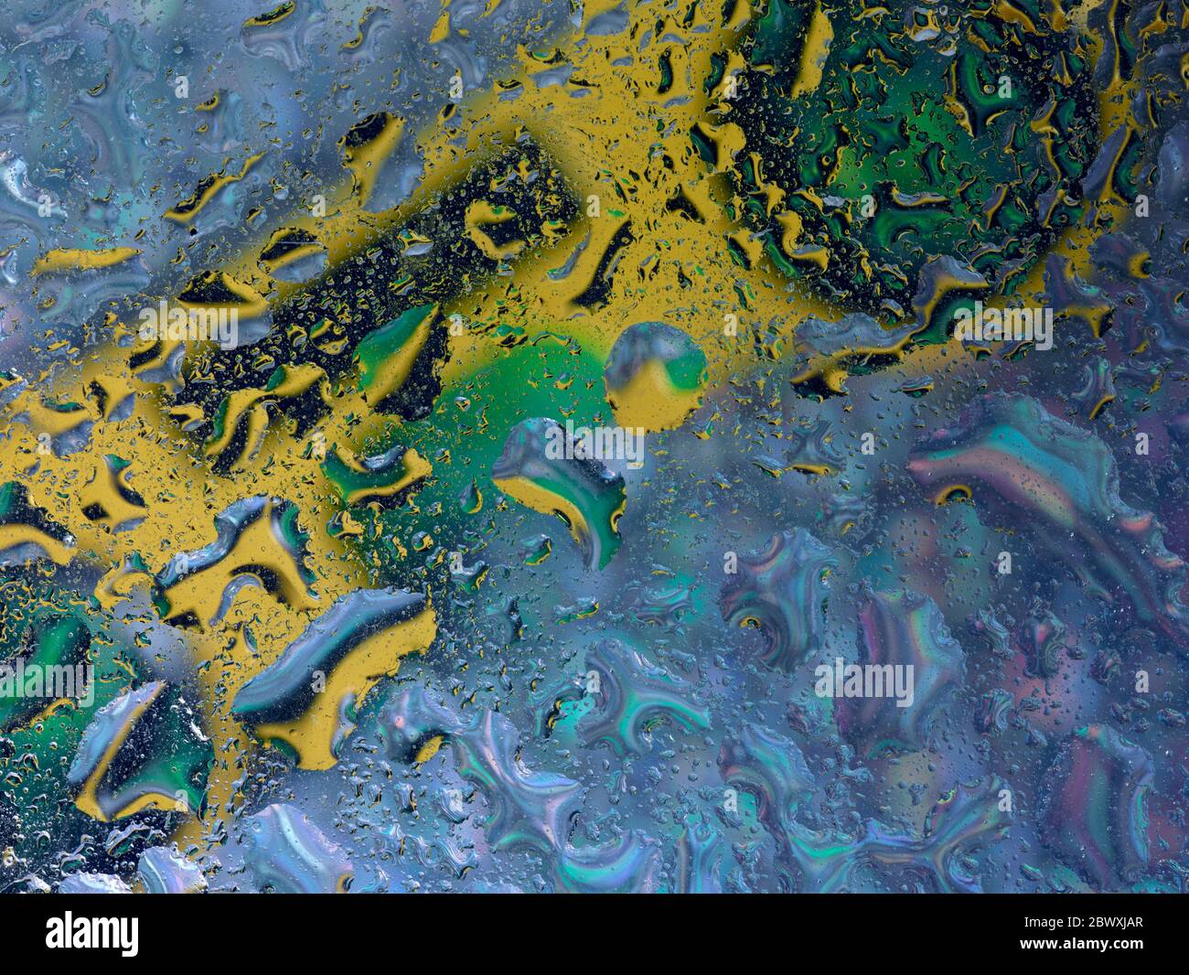 Water drop (drops and droplets) on hard surface with colourful ...