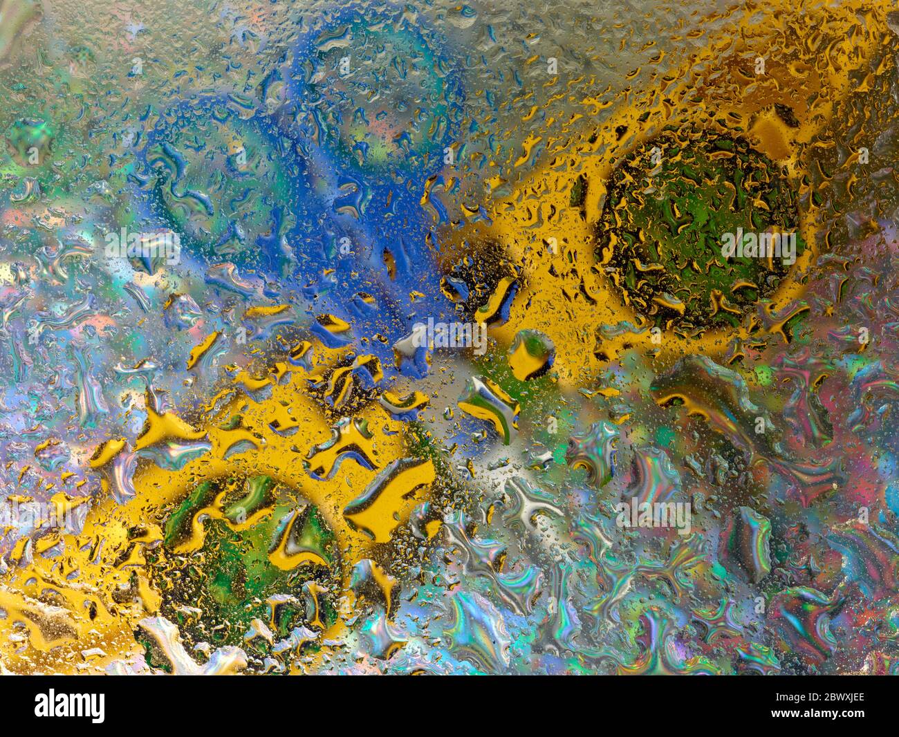 Water drop (drops and droplets) on hard surface with colourful ...