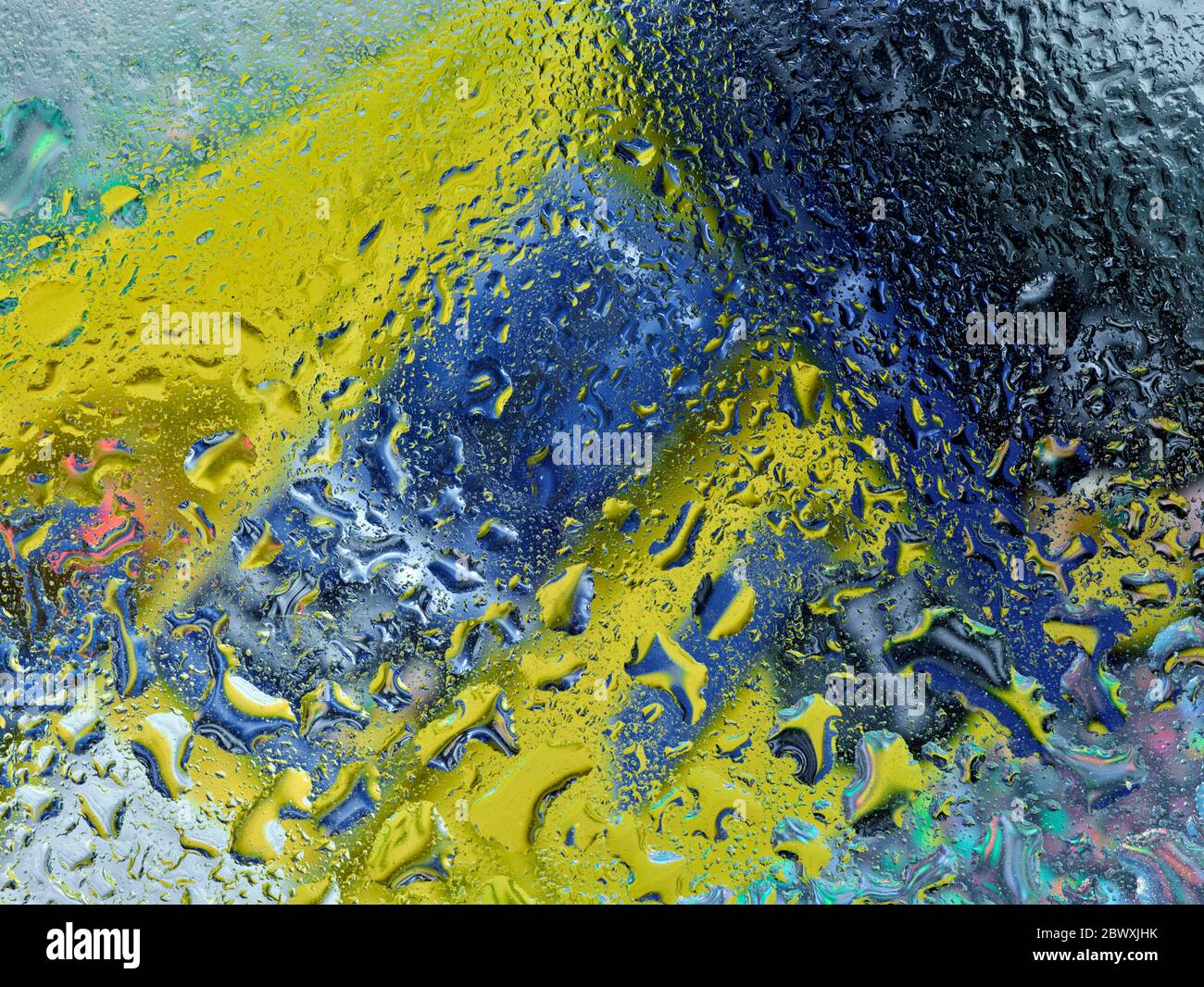 Water droplet patterns on hard surface with colourful background Stock ...