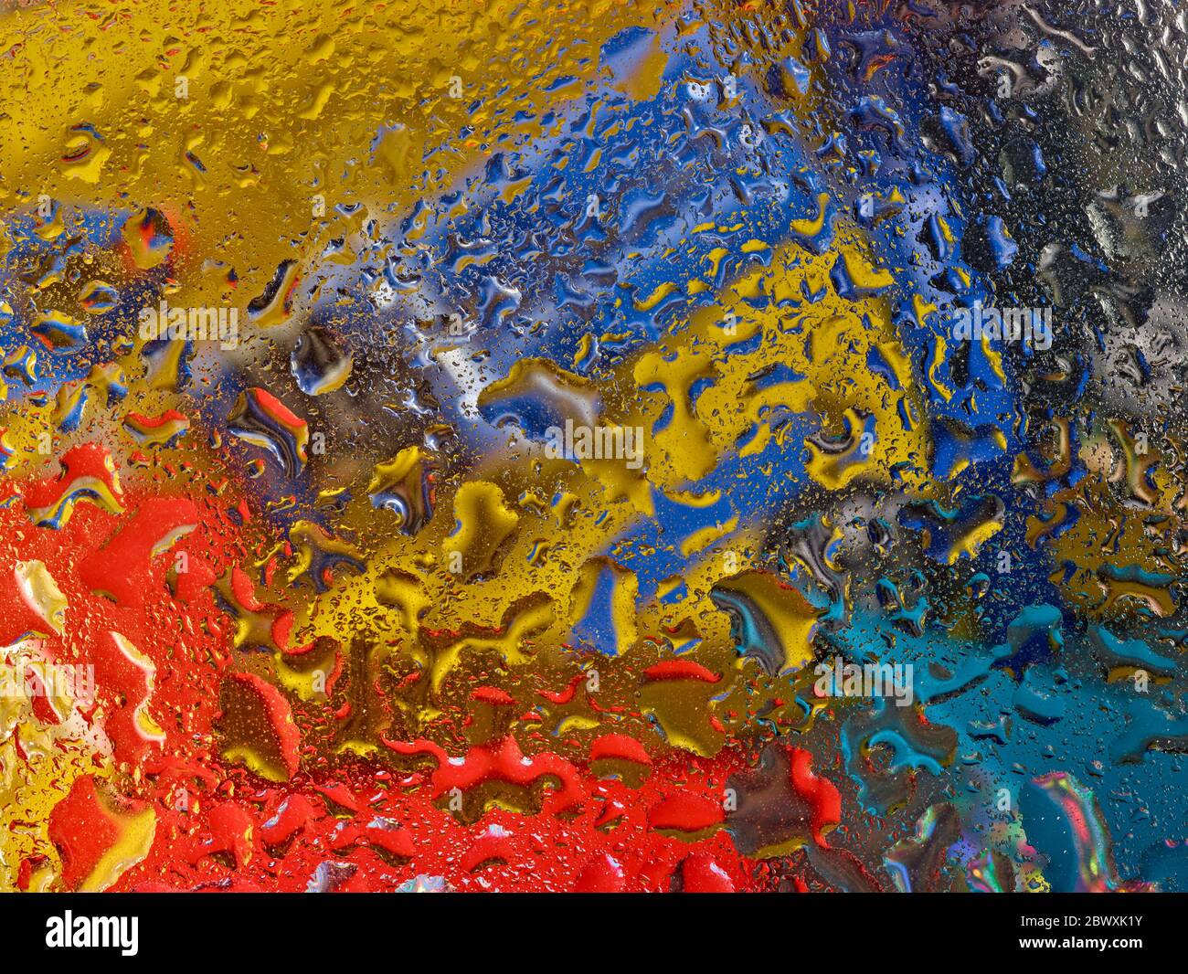 Water droplet patterns on hard surface with colourful background Stock ...
