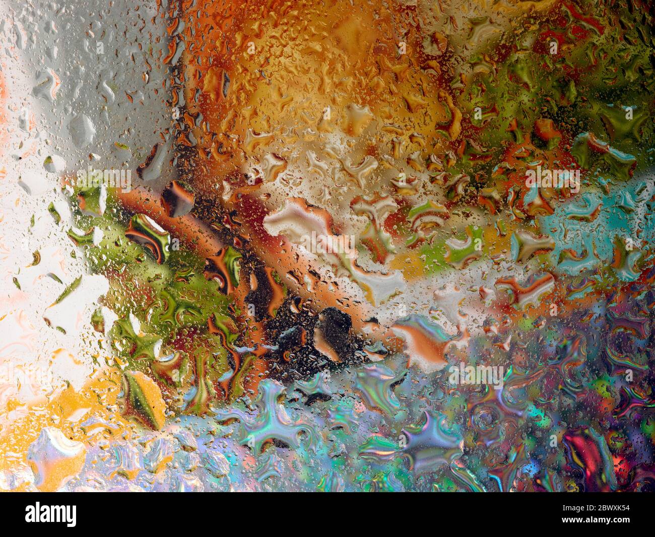 Water droplet patterns on hard surface with colourful background Stock ...